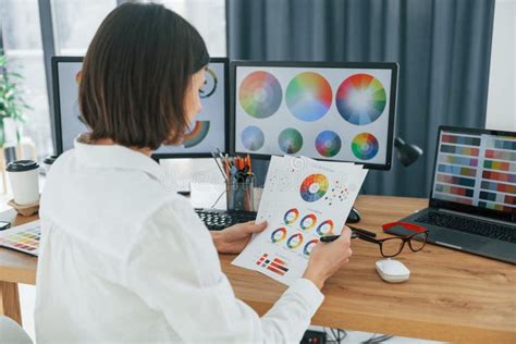 With Paper Female Designer Working In The Office By Using Pc Stock