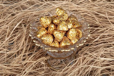 Chocolates Wrapped In Foil In Luxury Candy Chocolate Candies In A Box In A Gold Wrapper Stock