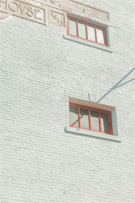 빨간 프레임 창문이 있는 흰색 벽돌 건물 사진 Unsplash의 무료 건물 이미지