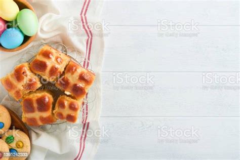 색깔이있는 달걀 부활절 진저 브레드 토끼 및 흰색 판자 나무 오래된 테이블 배경 위에 쿠키가있는 부활절 핫 크로스 만두 봄 휴가 베이킹 개념 부활절 테이블 설정 상단 보기