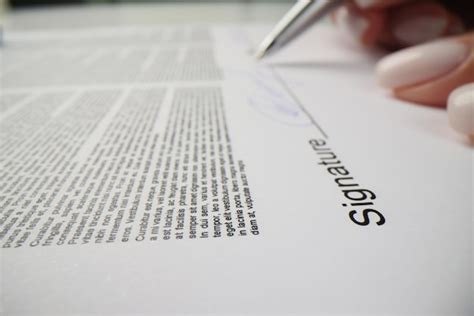 Premium Photo Woman Puts Personal Signature Above Line On Document Paper Sheet After Reading