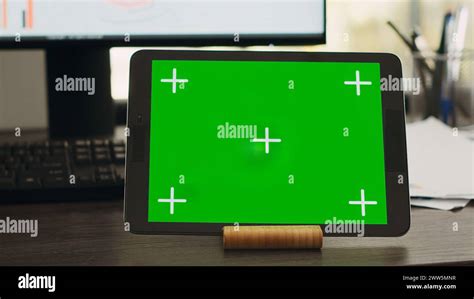 Empty Desk With Greenscreen On Tablet In Business Coworking Space Isolated Copyspace Layout On