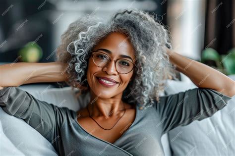 Premium Photo A Woman With Curly Hair And Glasses Is Smiling And