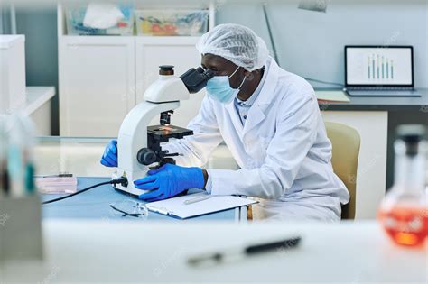 Premium Photo Side View Portrait Of Black Scientist Using Microscope In Medical Laboratory