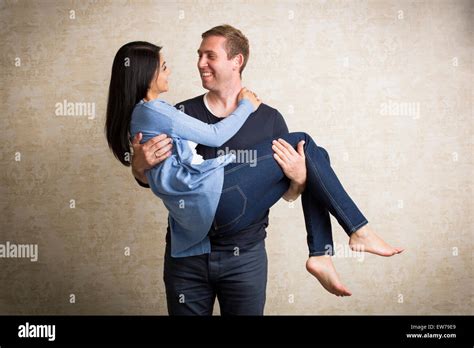 Man Carrying Woman In His Arms Stock Photo Alamy