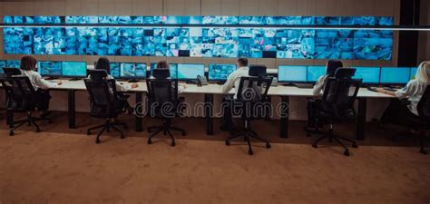 Group Of Security Data Center Operators Working In A Cctv Monitoring