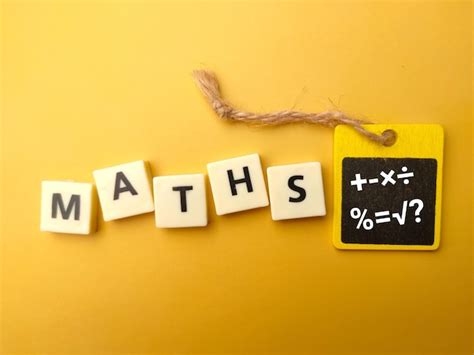 Premium Photo Cubes With The Word Maths And Math Symbols On Blackboard On Yellow Background