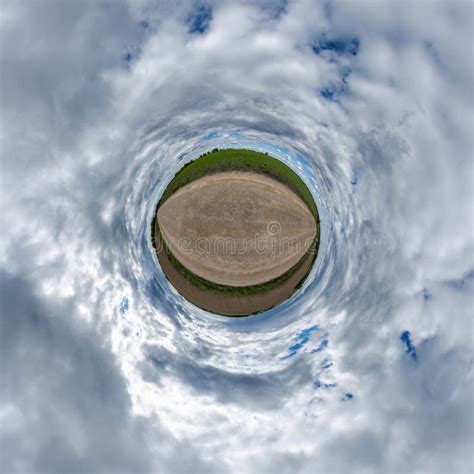 Tiny Planet In Blue Overcast Evening Sky With Beautiful Clouds With Transformation Of Spherical