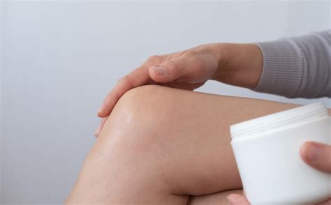Premium Photo Close Up Of A Person Rubbing Cream For Healing Injured