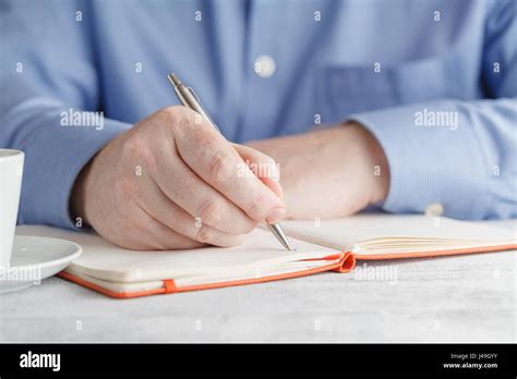 Male Hand Writing In Notebook With Pen Stock Photo Alamy