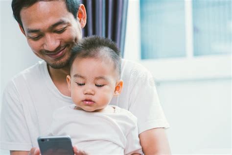 Man Father Working On Laptop Computer And Using Smartphone Technology Stock Photo Image Of