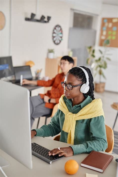 Focusing On Work With Headphones In Office Environment Stock Image