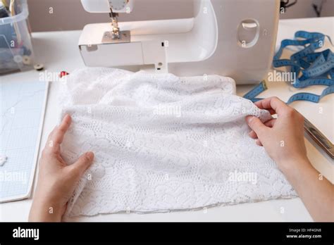 Woman Prepares Fabric For Sewing On Sewing Machine Close Up Stock Photo