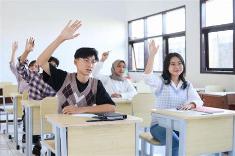 Premium Photo Students Raising Their Hands In Class For An Answer Premium Photo Students Raising Their Hands In Class For An Answer