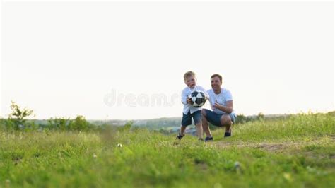 Funny Cunning Little Boy Runs Away From A Dad With A Ball Stock Video