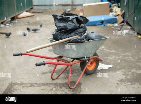 Garden Cart With Black Bags Inside Cleaning Of Territory Transportation Of Garbage Garbage