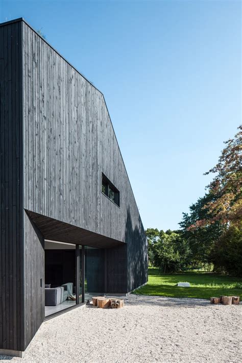 Villa Sg21 Is A Monolithic Blackened Wood House Topped With A Turfed Roof