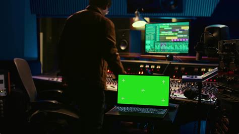 Music Producer Recording Tracks Next To Laptop Showing Mockup Isolated Display Working With