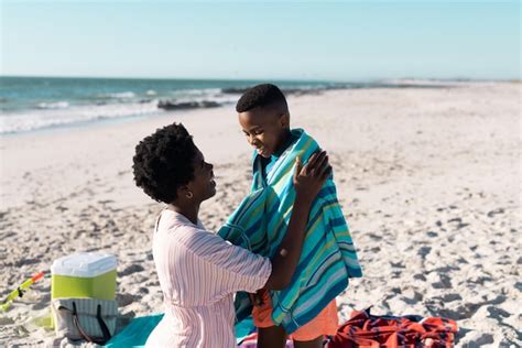 Premium Photo African American Woman Wrapping Towel Around Wet Son