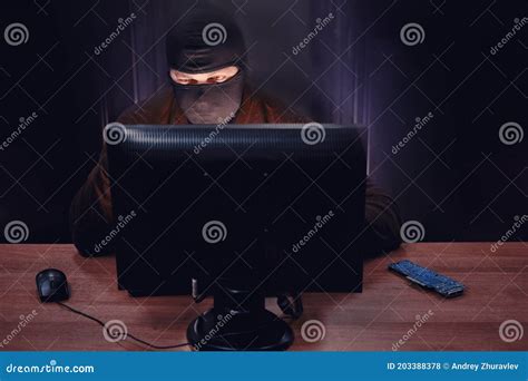 Hacker In Balaclava Steals Information In The Server Room Concept Of Data Integrity Issues And