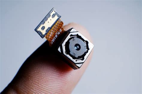 Premium Photo Tiny Small Camera Module In Fingertip