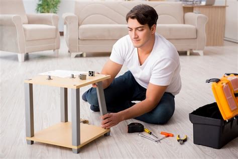 Man Assembling Shelf At Home Premium Photo