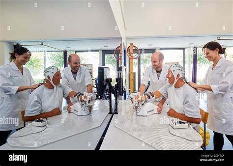 Investigator And Patient With Assistive Robot For Upper Limb