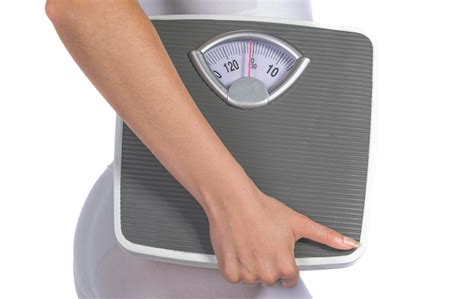 Premium Photo Female Model Holding Scale And Measuring Tape Over White Background