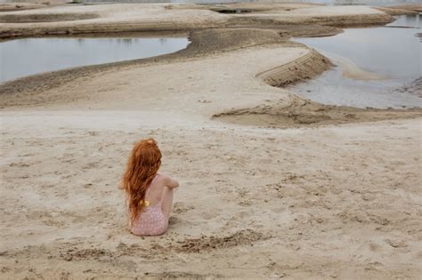 Premium Photo Little Redhead Girl Playing On A Beach