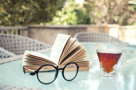 Premium Photo Close Up Of Glasses And An Open Book On Table