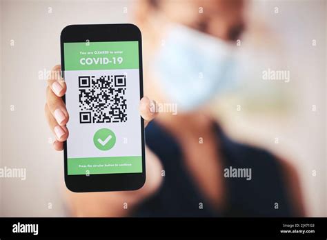 Covid Passport Qr Code And Phone In The Hand Of A Woman Refugee Or