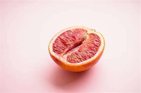 Premium Photo Half Of A Blood Orange On Pink Background Sex Concept