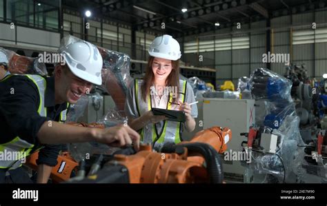 Both Of Engineers Working Together In A Robotic Arm Factory Robotic Arm Industry And