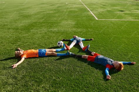 Premium Photo Happy Tired Football Player Lying Like Star On Green Field Young Exhausted