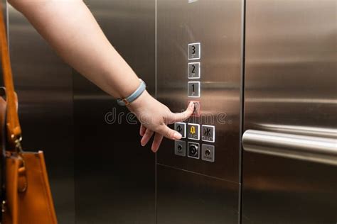 pressing elevator button person with handbag using elevator in office
