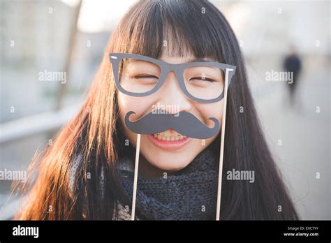 Young Beautiful Asian Hipster Woman In The City With Funny Fake