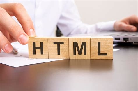 Premium Photo Man Made Word Html With Wood Blocks On The Background Of The Office Table