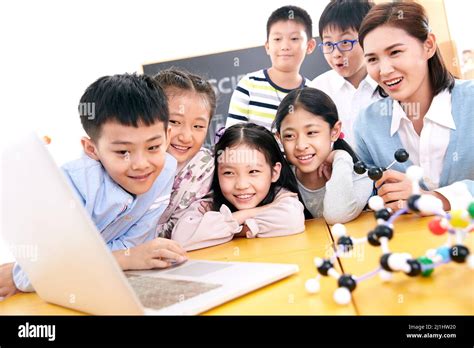 Female Teachers And Babes Use Computers In The Classroom Stock Photo Alamy