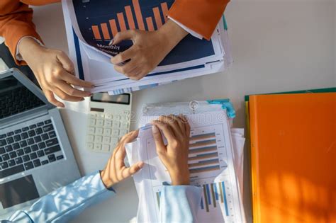 Two Businesswomen Are Working Together To Search Through Important