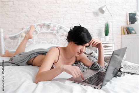 Naked Woman Typing On Laptop In Bedroom Front View On Typing Massage On Laptop Woman Lying On