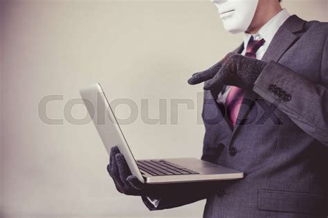 Business Man In White Mask Wearing Gloves And Using Computer Fraud Hacker Theft Cyber Crime