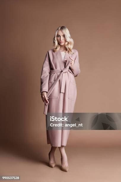 아름 다운 금발의 여자는 베이지색 바탕에 핑크 코트에 포즈 패션쇼에 의류 완벽 한 그림 긴 머리를 가진 여자 여자의 몸에 유행 유행가 코트 여자에 대한 스톡 사진 및 기타
