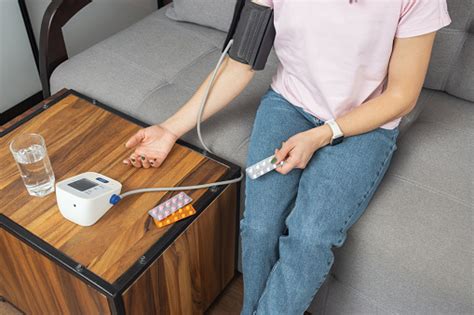 집에서 소파에 앉아서 현대 디지털 안압계로 손에 혈압을 측정하는 알아볼 수 없는 젊은 여성 건강 검진에 대한 스톡 사진 및 기타 이미지 건강 검진 건강 진단 건강