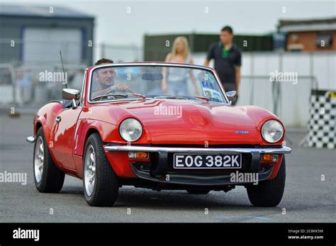 Triumph Spitfire Driving Across The Paddock At Santa Pod Raceway Stock
