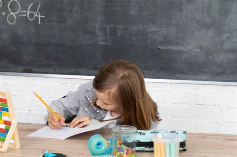 Premium Photo The Girl Solves The Task Given In The Classroom The