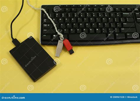 Computer Keyboard External Hard Drive And USB Flash Drive Displayed On A Yellow Background