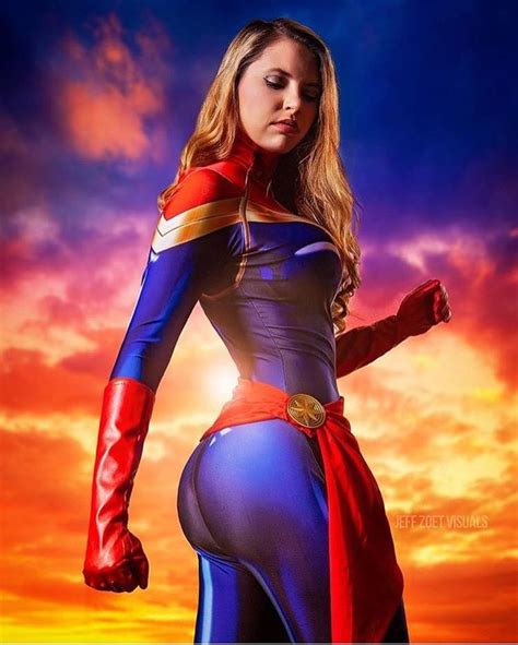 A Woman In A Superhero Costume Posing For The Camera With Her Hands On