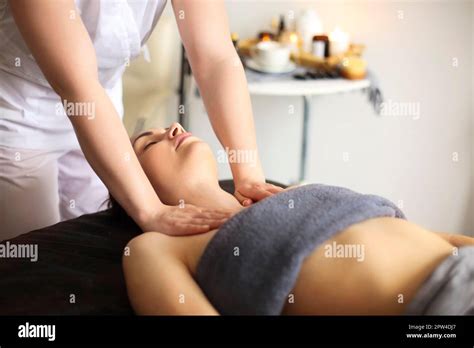 Unrecognizable Crop Masseur Massaging Chest Of Female Client Lying On