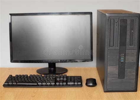 computer monitor with keyboard and mouse on a wooden desk stock image