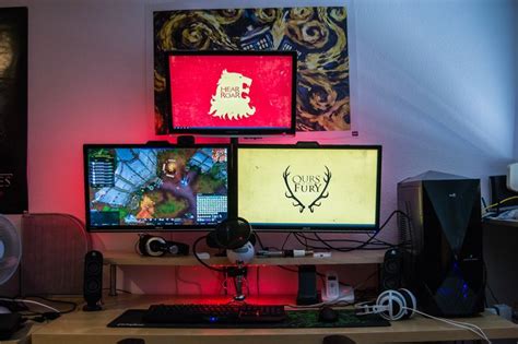 Three Computer Monitors Sitting On Top Of A Desk